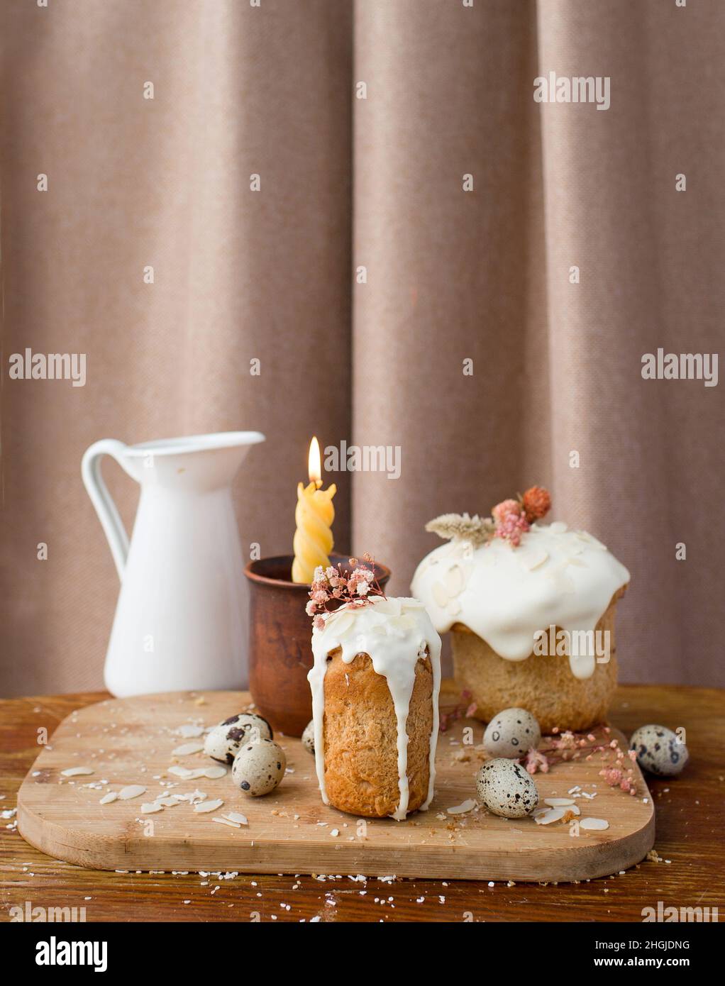 traditional Russian Easter cake with icing and quail eggs and a burning ...