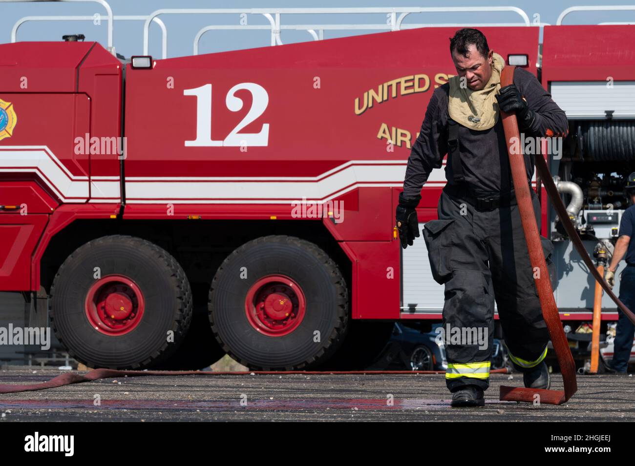 A member of the Ruidoso Fire Department carries a water hose during an ...