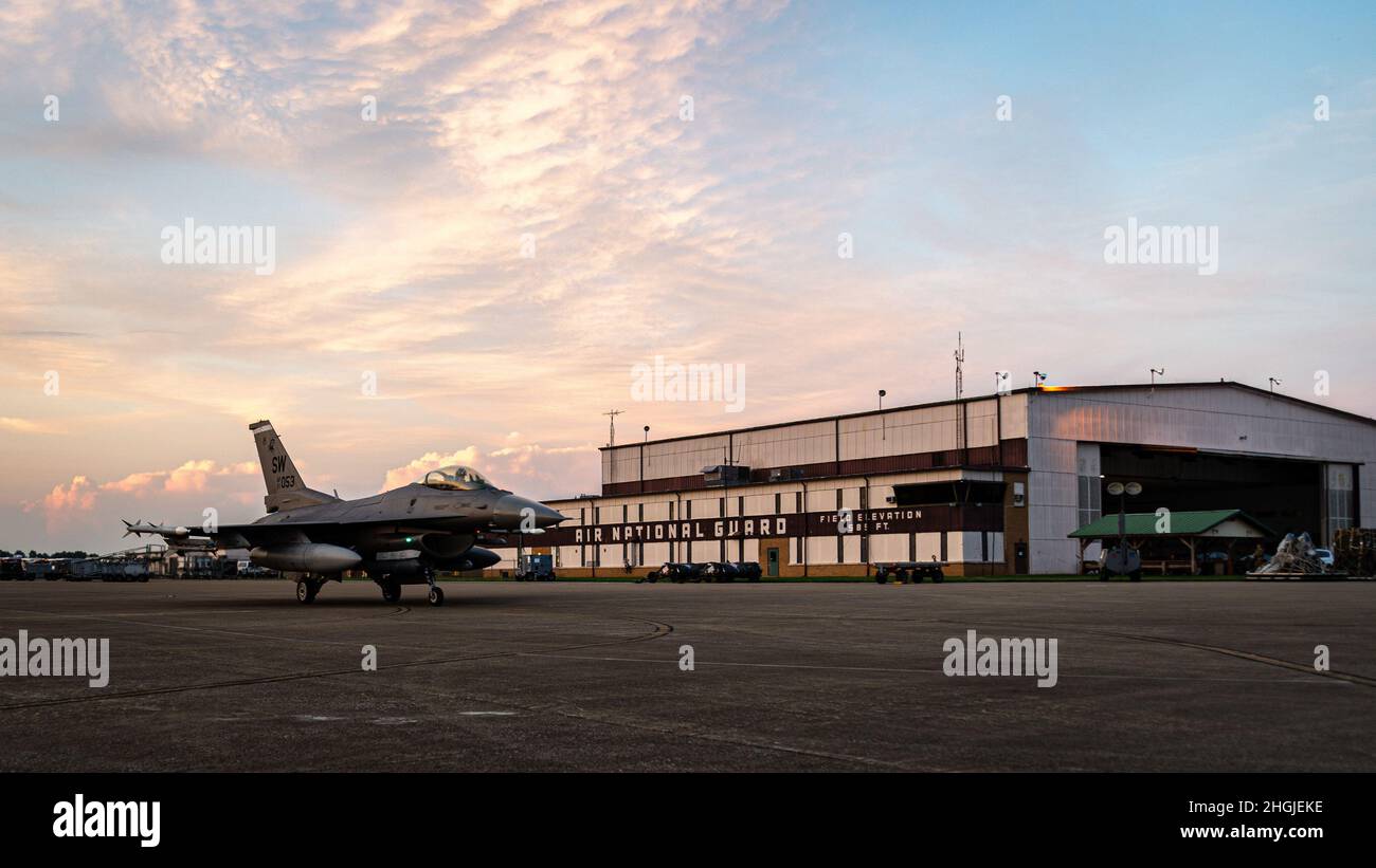 An F-16 Fighting Falcon from the 55th Fighter Squadron taxis in front ...
