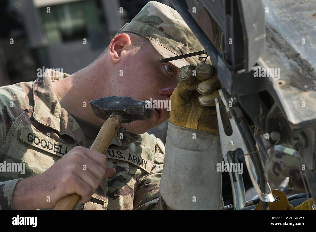 Idaho Army National Guard PV2 Zach Goodell works at trying to remove a ...
