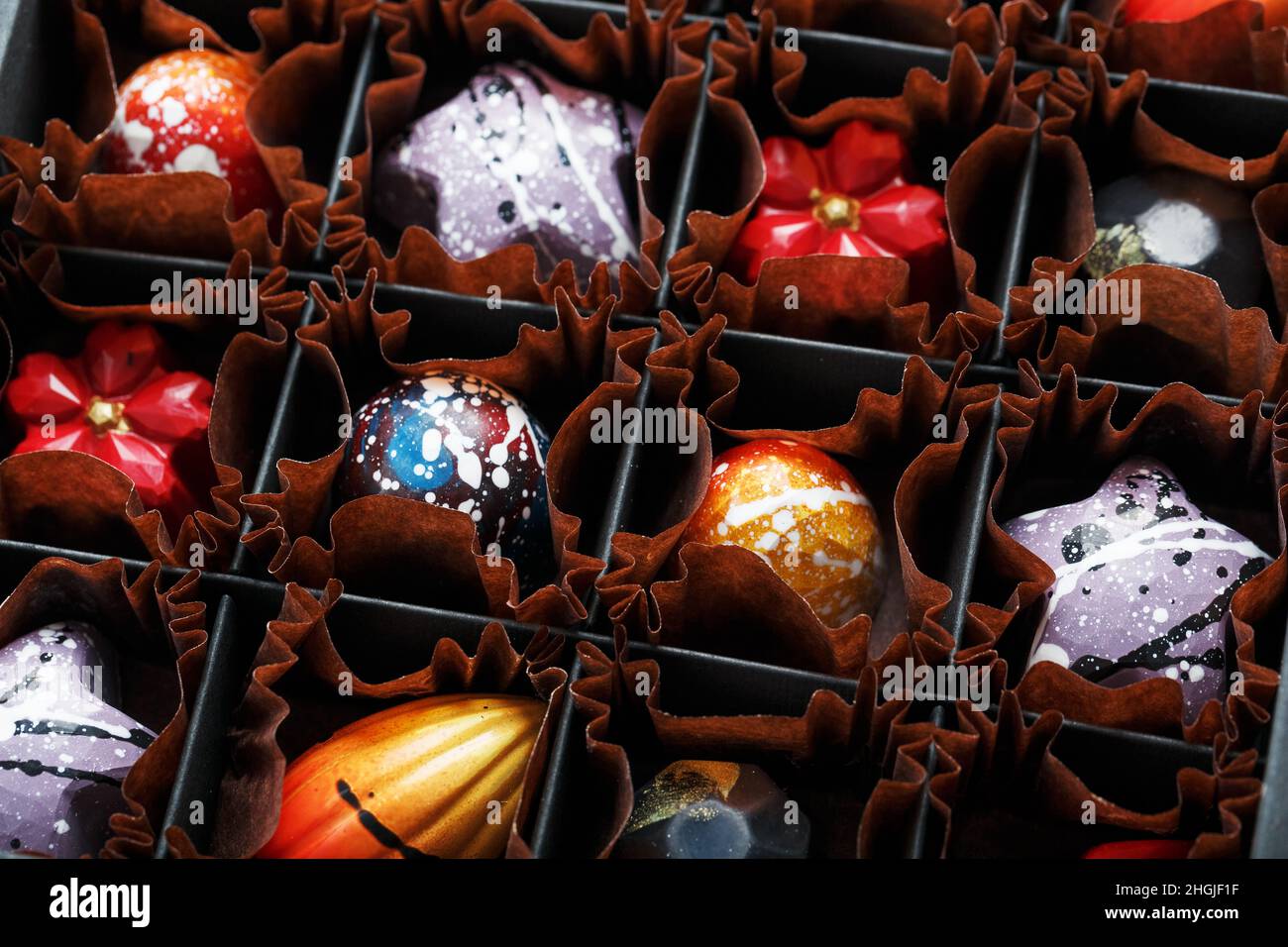 Handmade chocolates in a box. Production of confectionery products ...