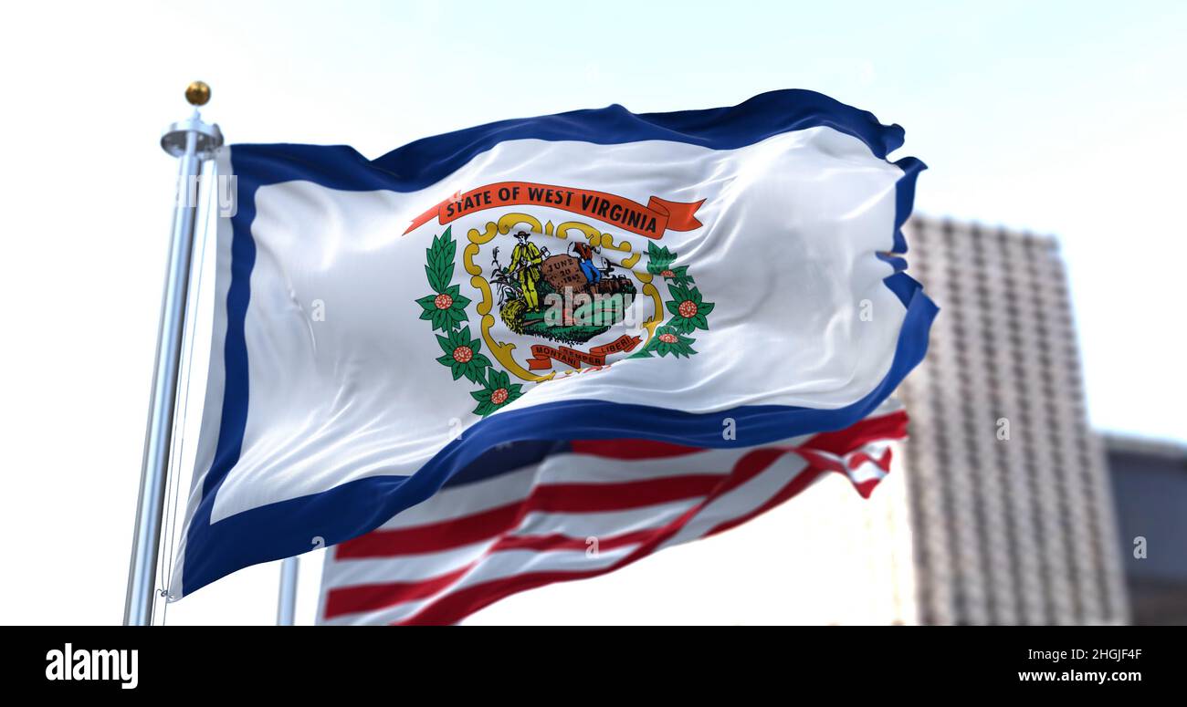 the flag of the US state of West Virginia waving in the wind with the ...