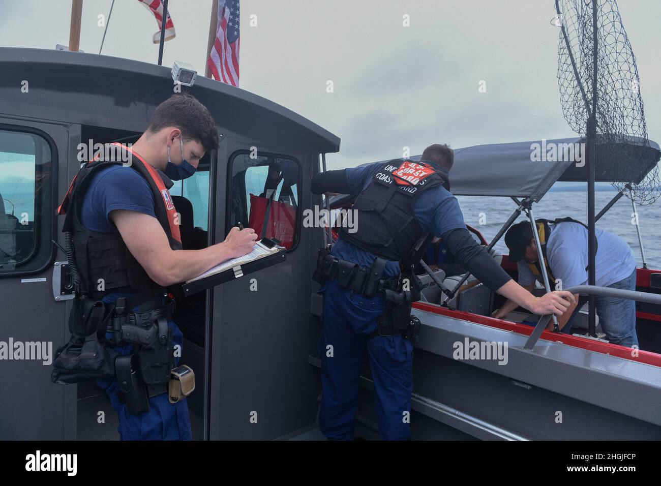 Petty Officers 3rd Class Colin Ryan and Lane Martin, boarding team ...