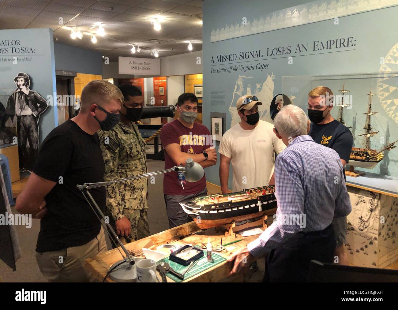 Sailors assigned to USS Vicksburg (CG 69) meet with Lee Martin, a ...