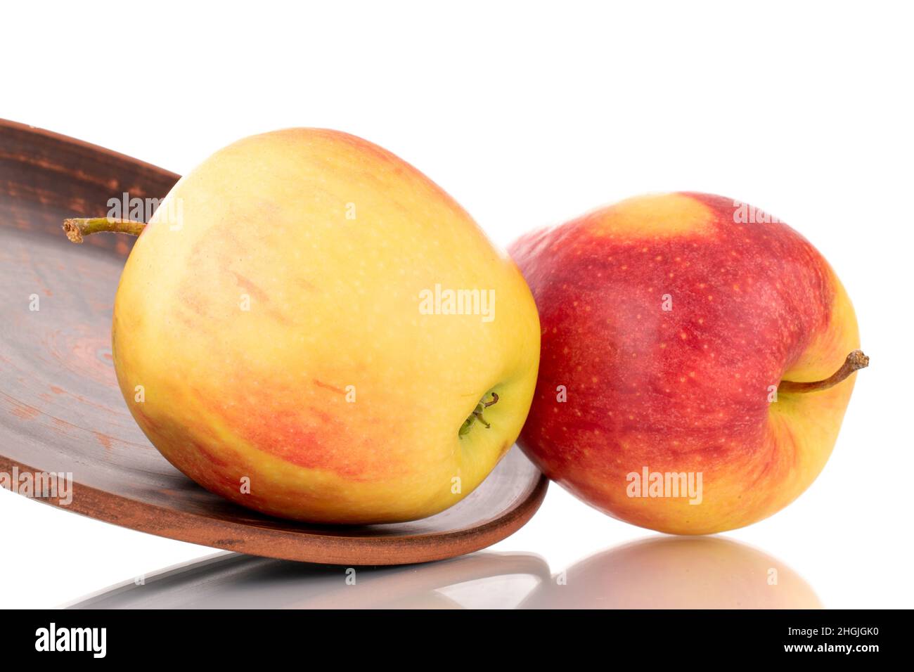 Three red juicy apples on a clay plate, macro, isolated on white Stock ...