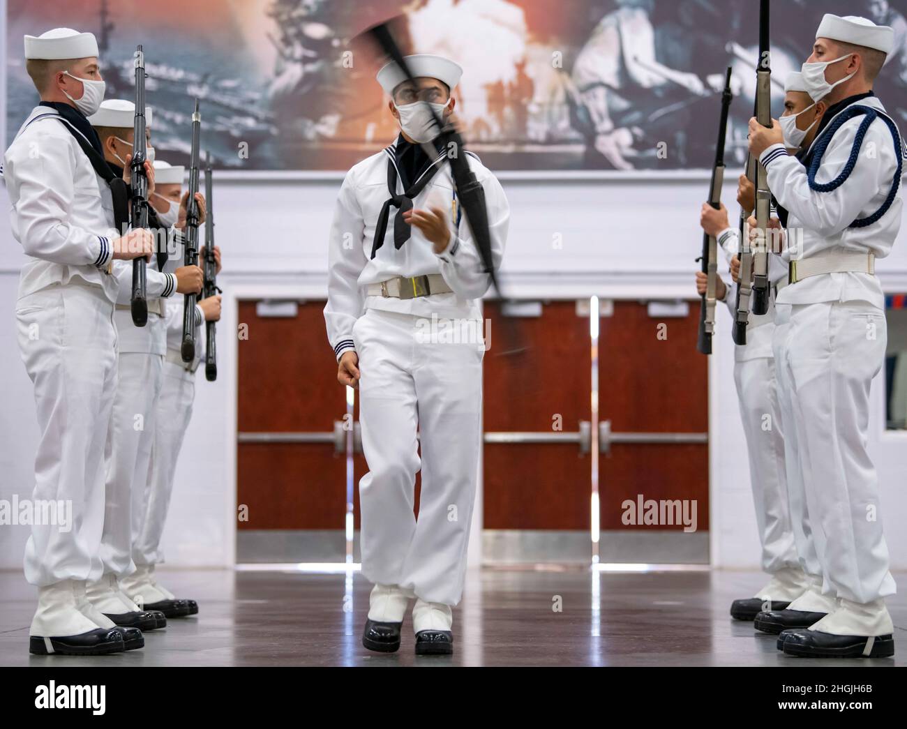 Members of the recruit drill team perform during a pass-in-review ...