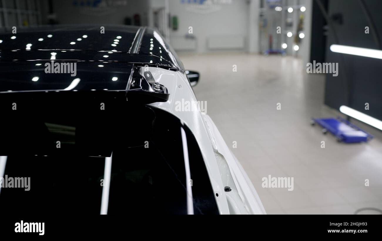 Electric car under repair. White car body. Vehicle detailing. Car under ...