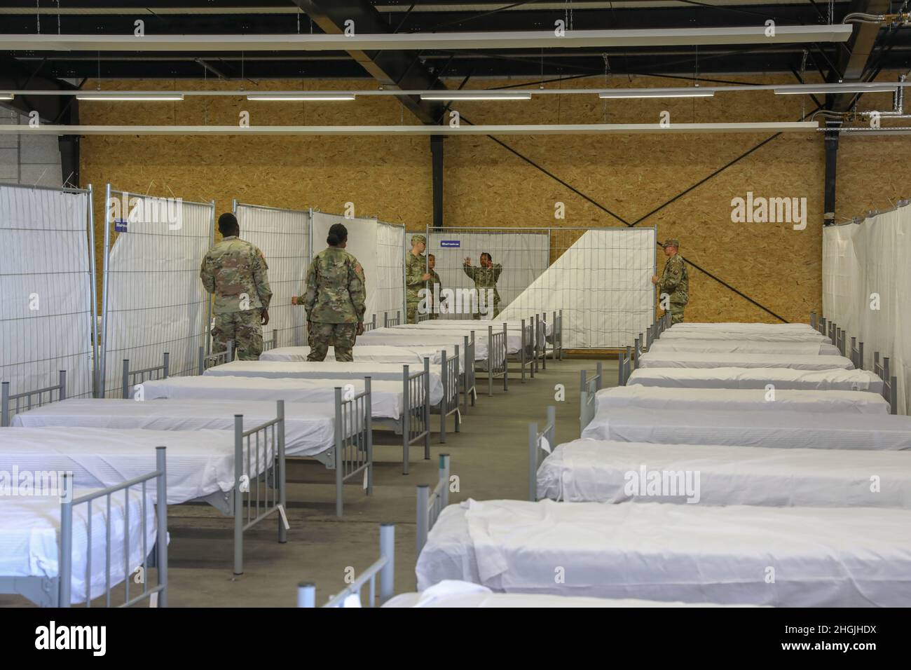 Soldiers from the 16th Sustainment Brigade set up beds and dividers at ...