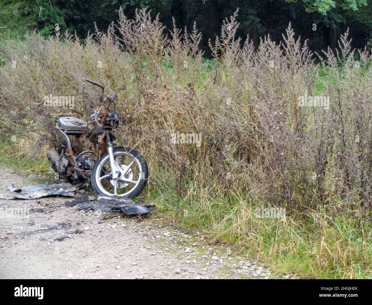 Stolen, burned out and abandoned motorcycle in the countryside Stock ...