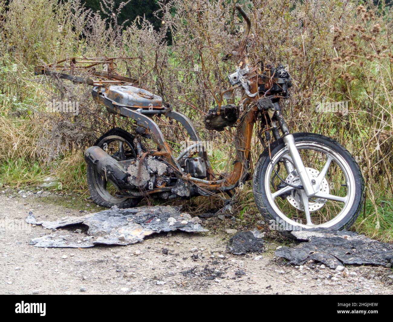 Stolen, burned out and abandoned motorcycle in the countryside Stock ...