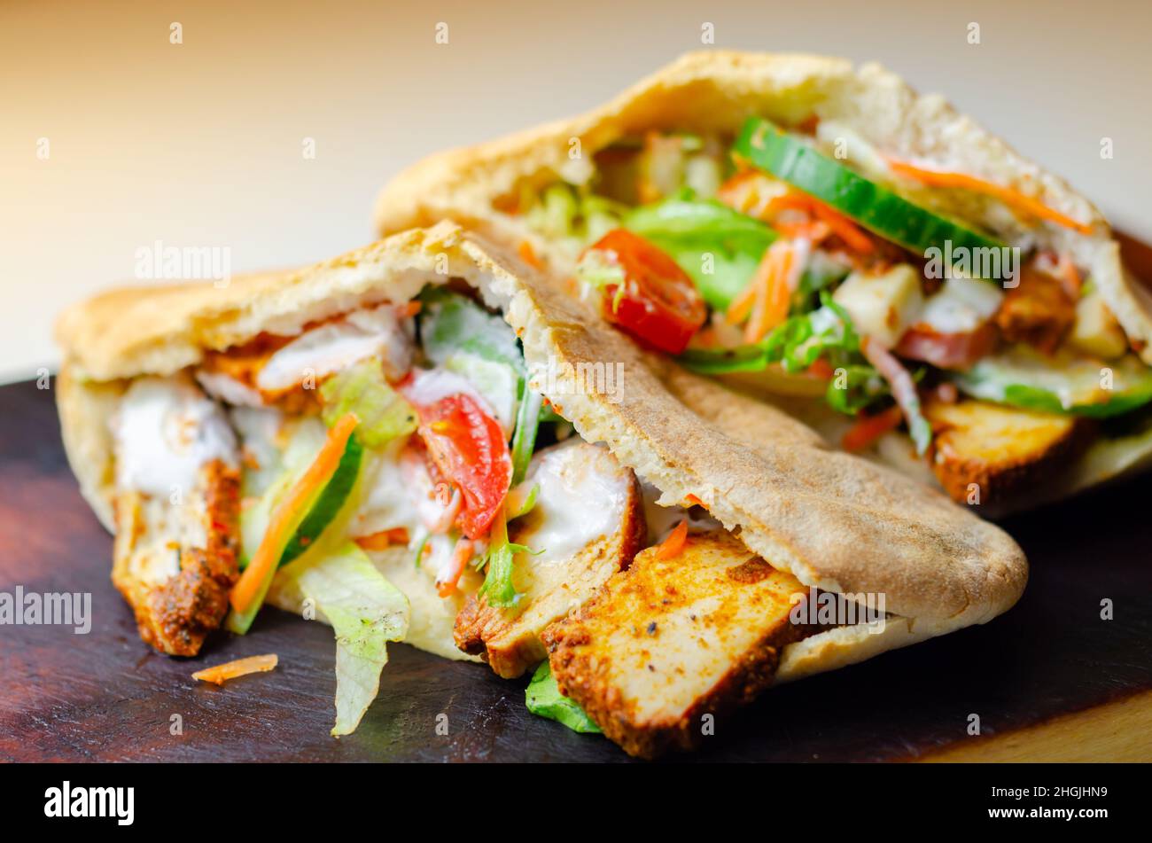 Mediterranean style pitta prepared with spicy chicken, cucumber, tomato ...