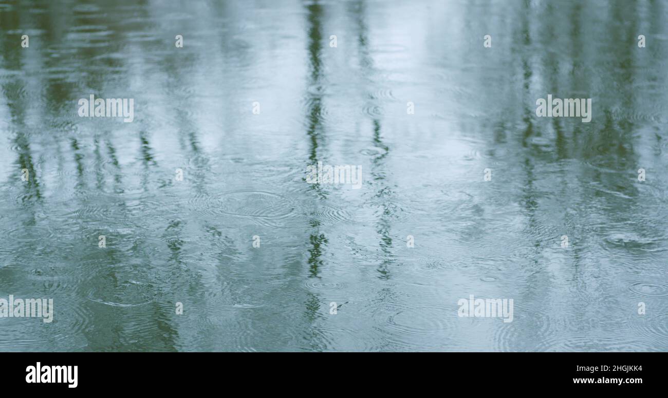 Heavy Rain Raining on a Water Surface Stock Photo - Alamy