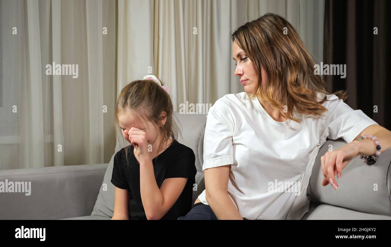 Teen girl complains crying while mother calms daughter Stock Photo - Alamy