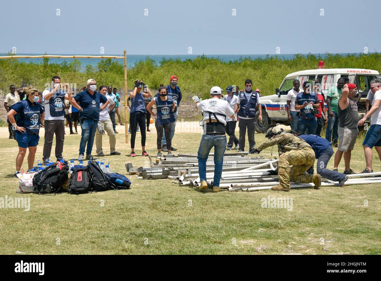 A U.S. Army CH-47 Chinook Helicopter crew chief assists a partner ...