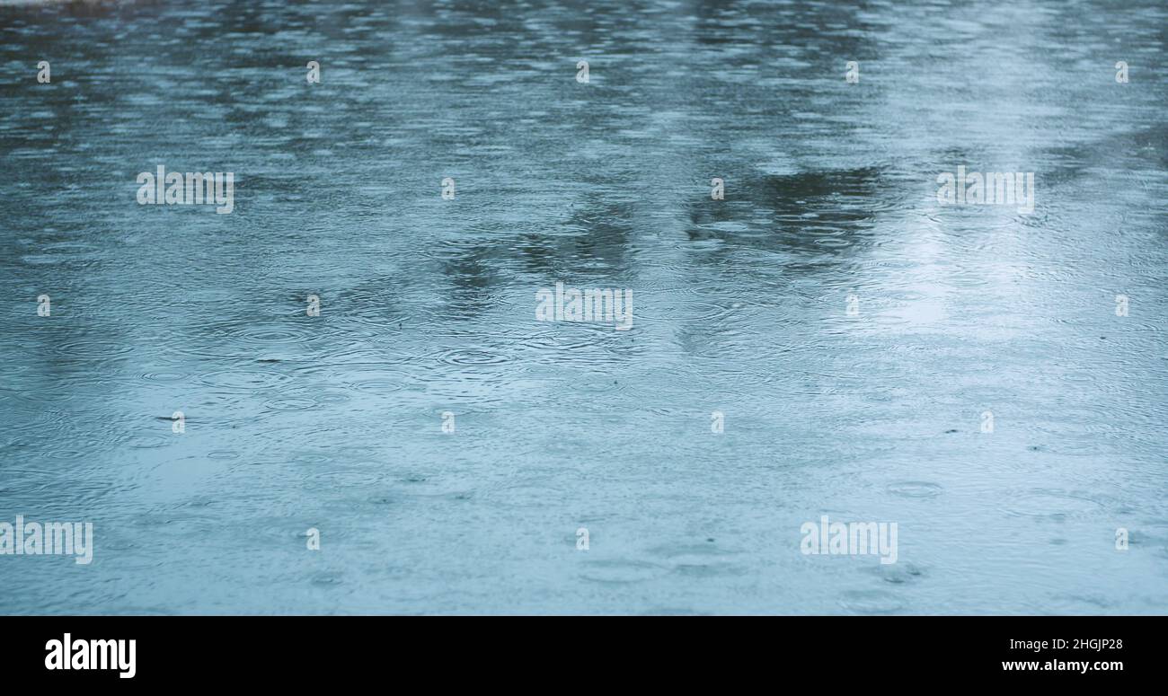 Heavy Rain Raining on a Water Surface Stock Photo - Alamy