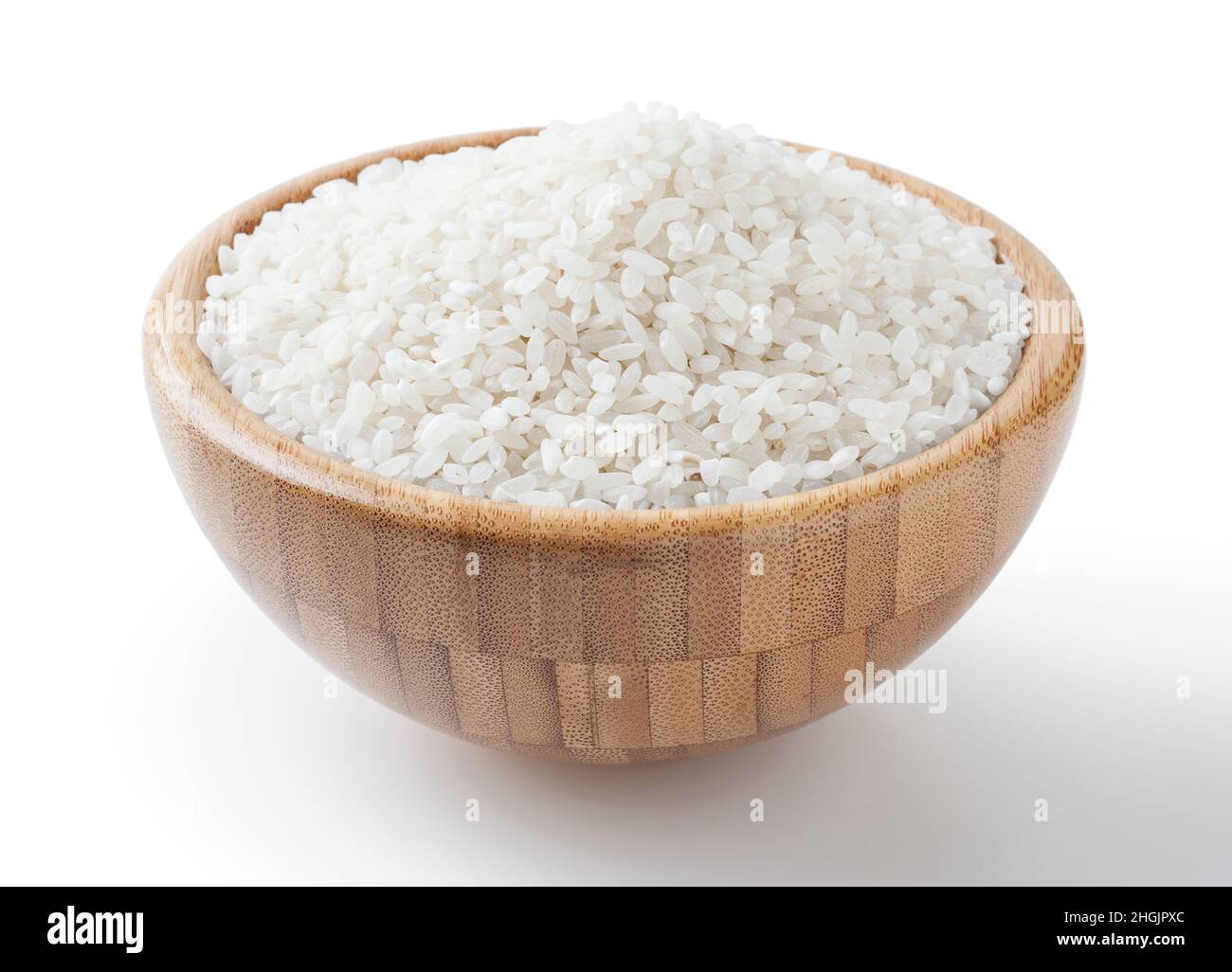 Uncooked round rice in wooden bowl isolated on white background with ...