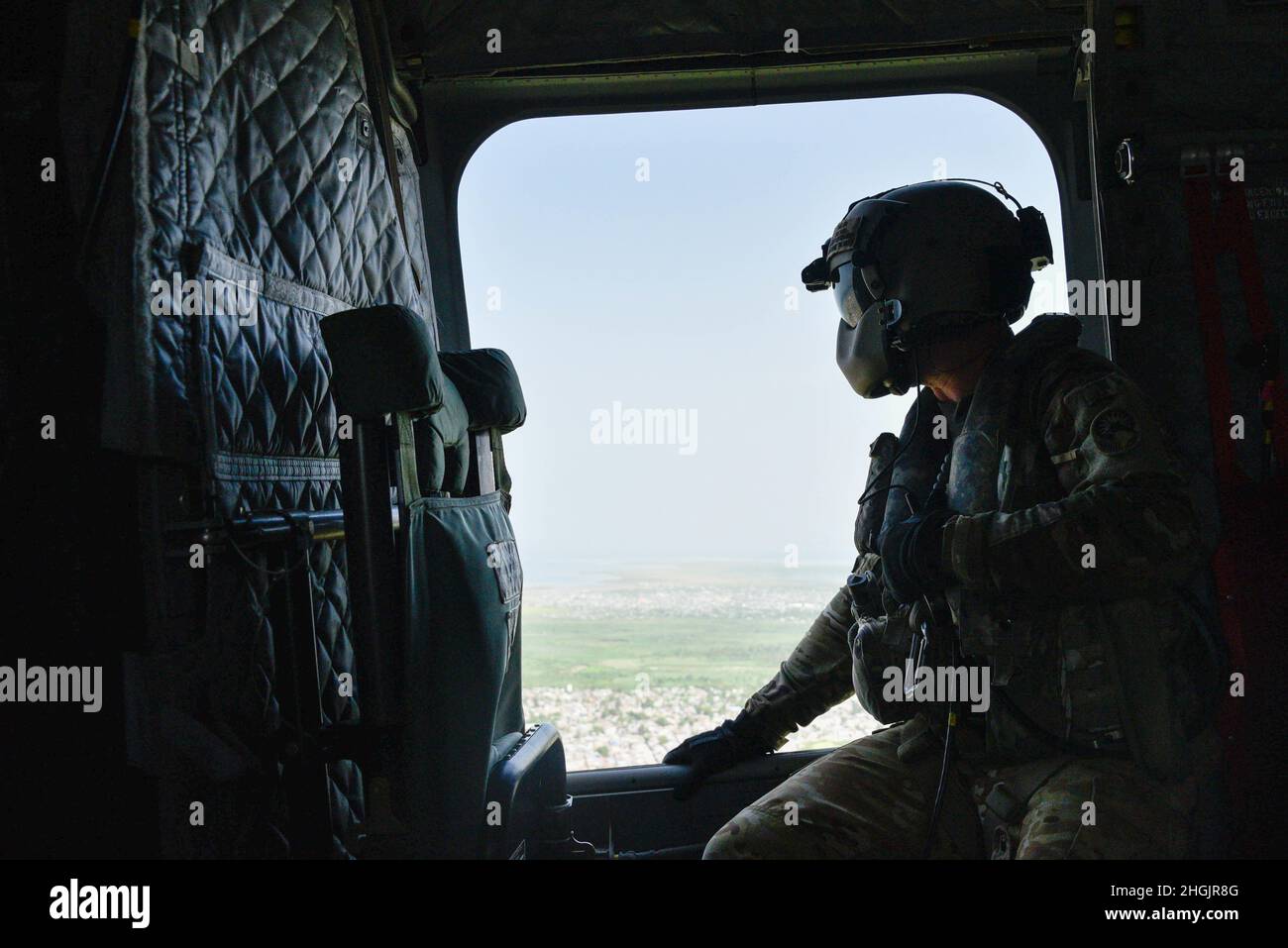 2. A U.S. Army CH-47 Chinook Helicopter crew chief aboard a flight to ...