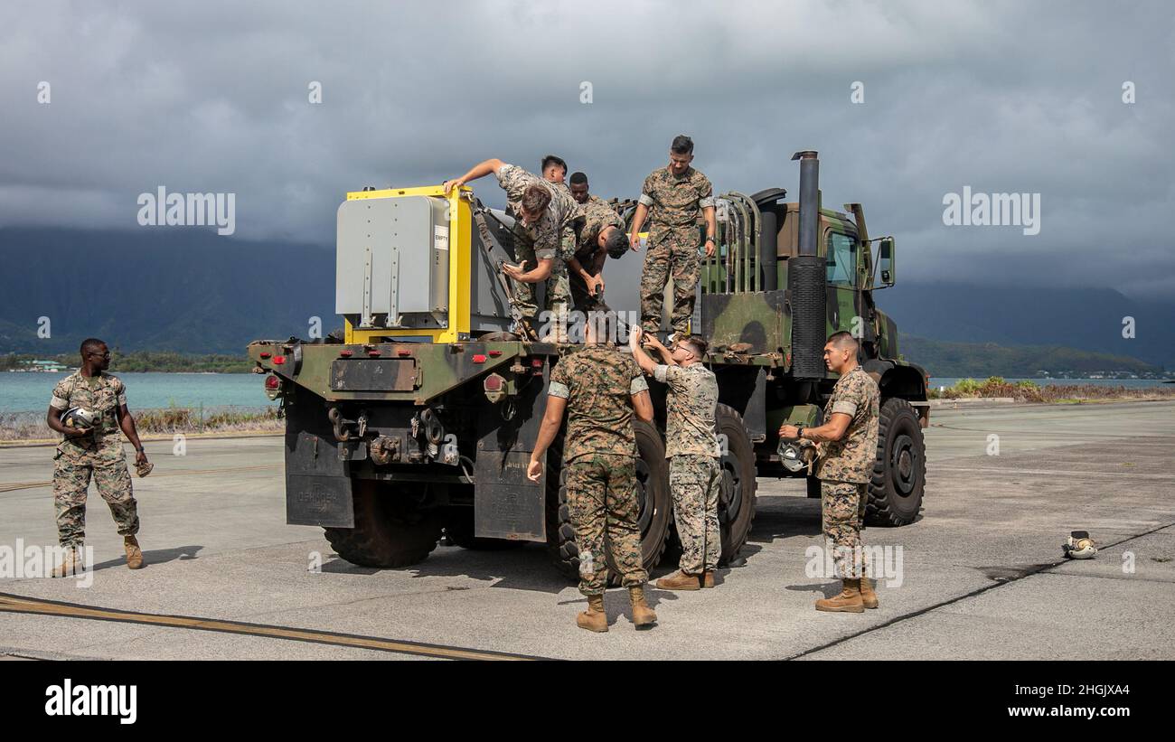 U.S. Marines with 1st Battalion, 12th Marine Regiment unstrap a Naval ...