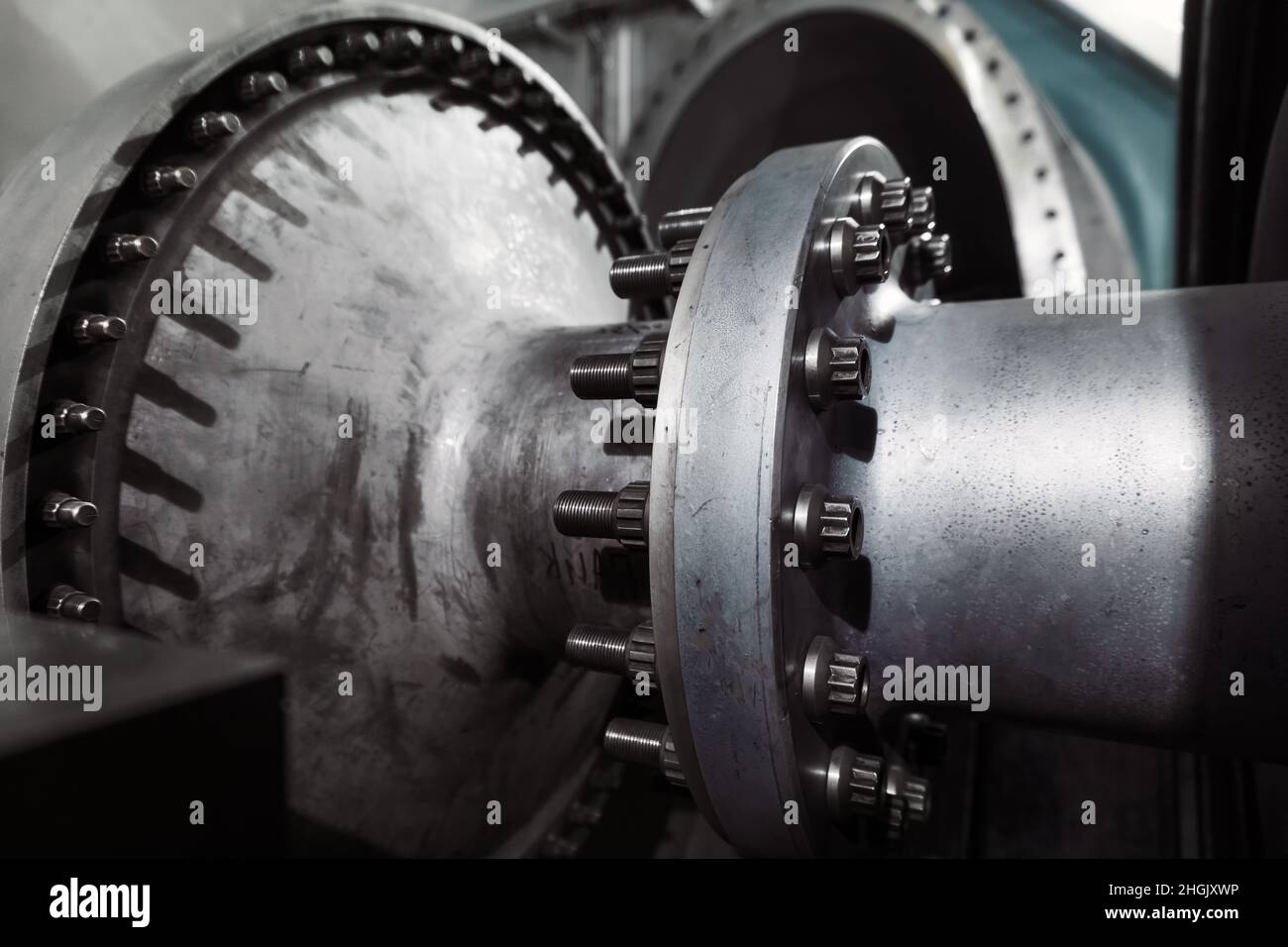 A gas turbine with a compressor rotor and a bolted coupling half ...
