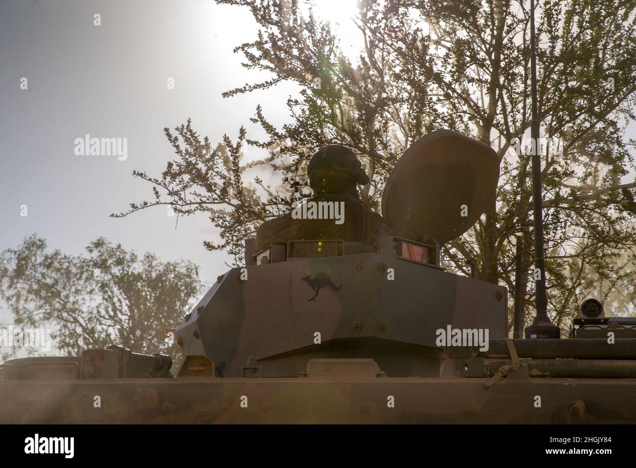 An Australian Army soldier sits in the turret of an Australian M113AS4 ...