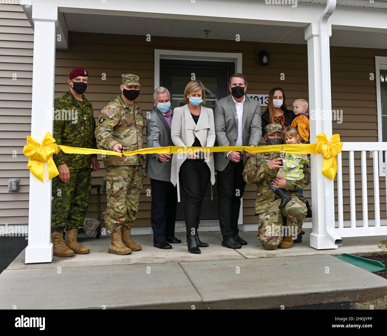 Sgt. Damian McGregor, his wife Rebekka, and their children help cut the ...