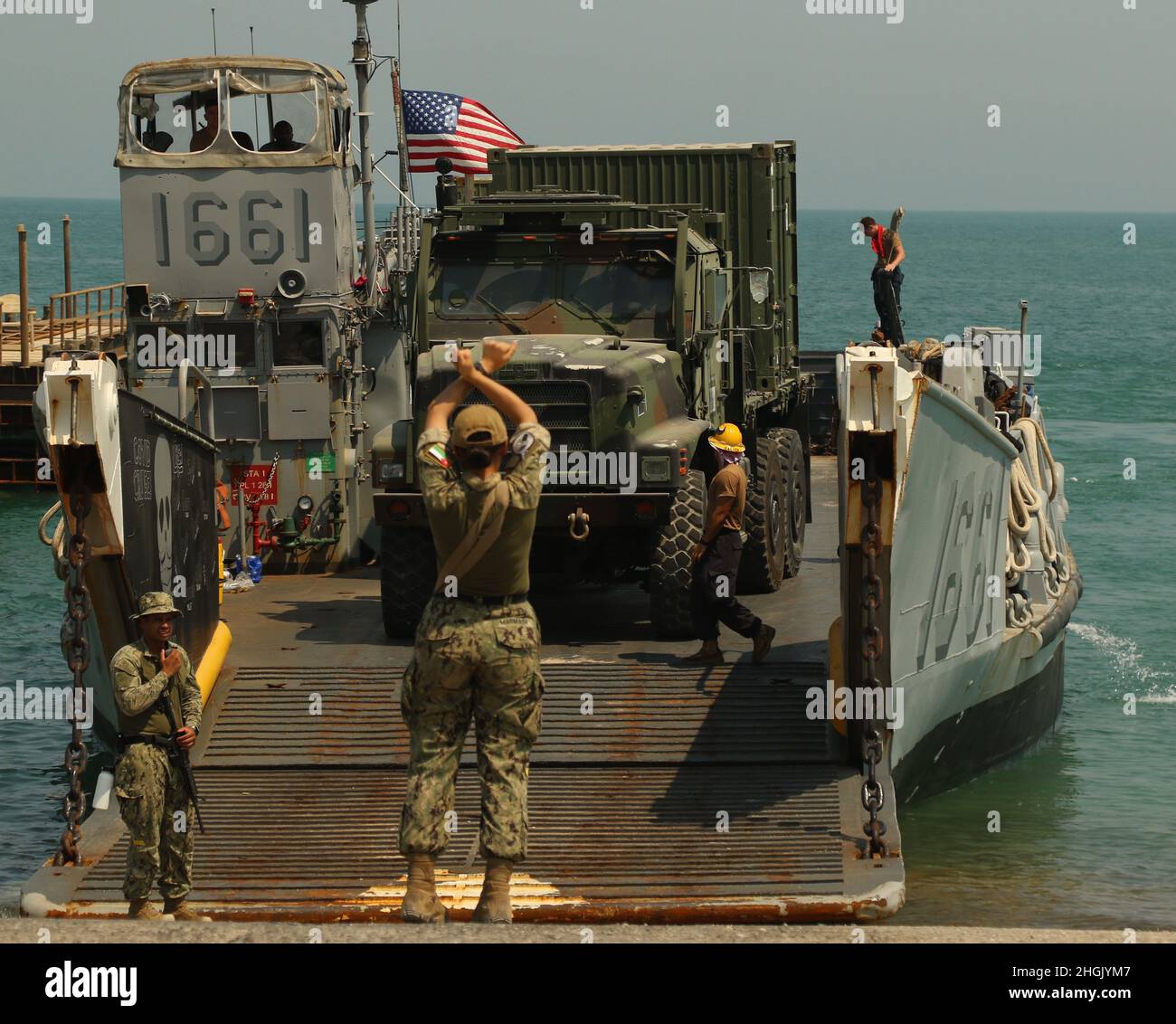 U.S. Navy Sailor, Seamon Yusra Marmash ground guides U.S. Marines ...