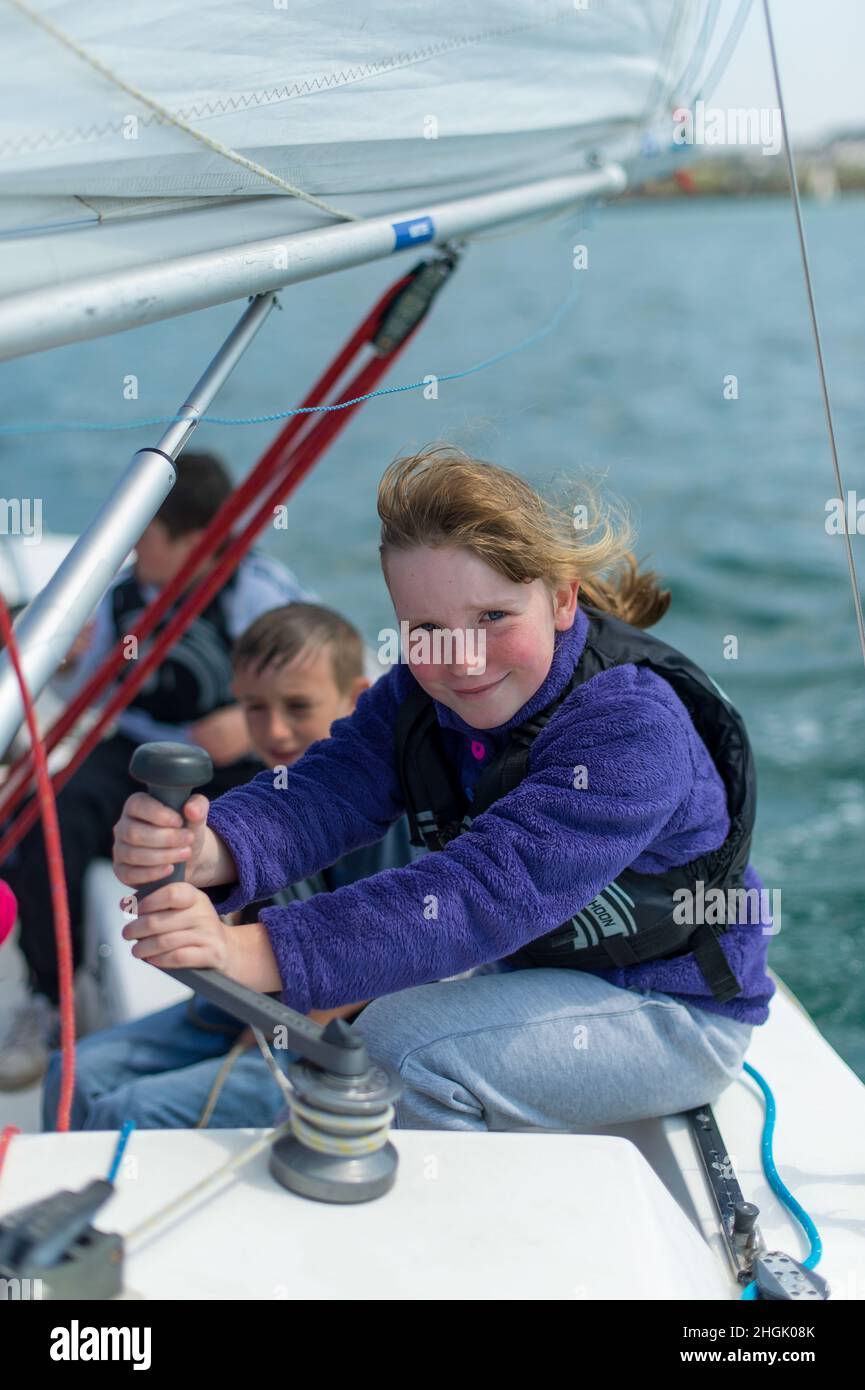 A young girl on a sailing lesson on a boat Stock Photo - Alamy