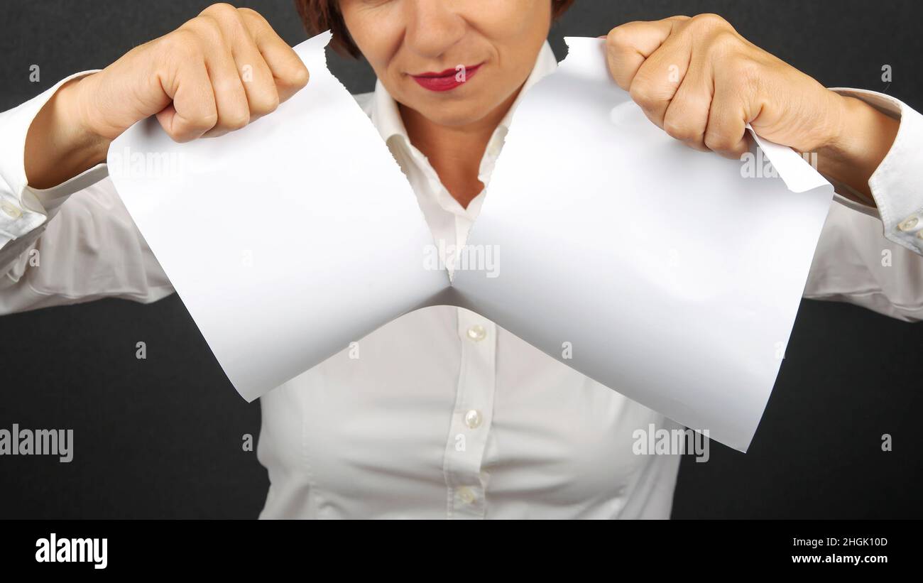Beautiful business woman tearing white paper in half Stock Photo - Alamy