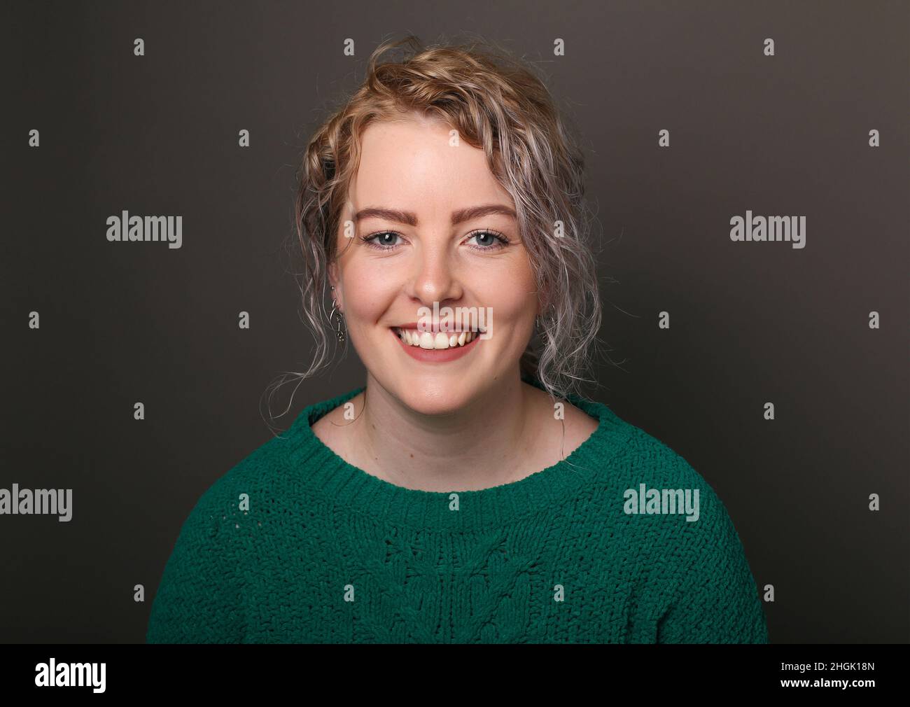 Portrait of a beautiful happy woman in front of a colored background ...