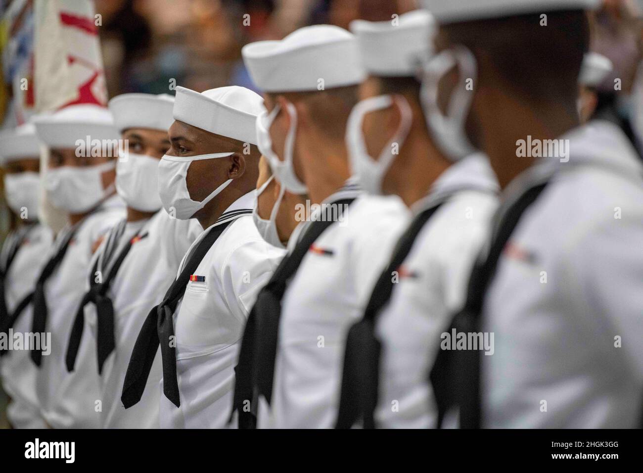 Sailors graduating from boot camp dress off in formation after entering ...