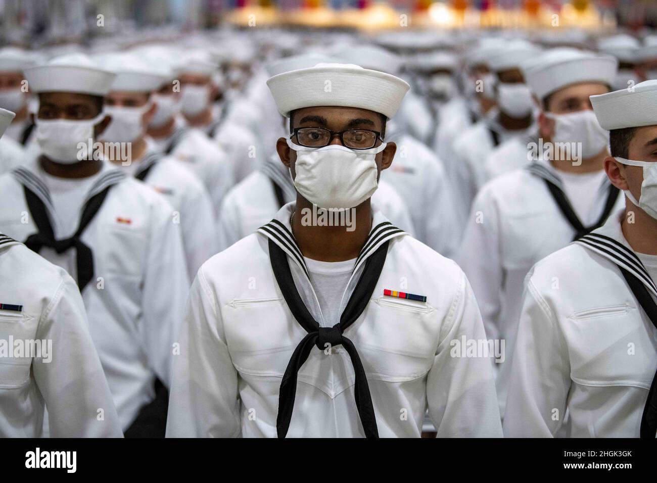 Sailors graduating from boot camp stand in formation after entering ...