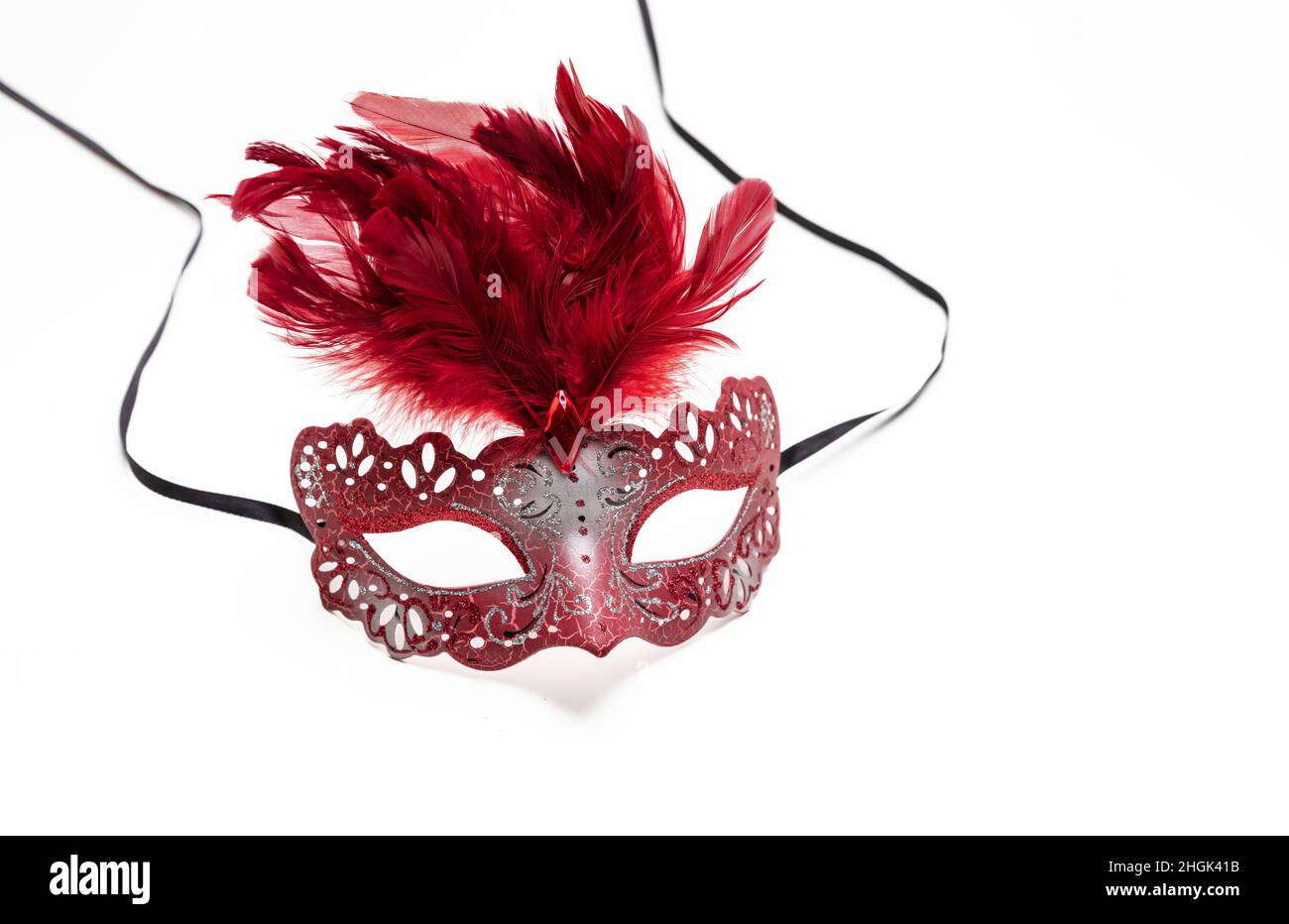 Carnival mask red color with feather isolated on a white background ...
