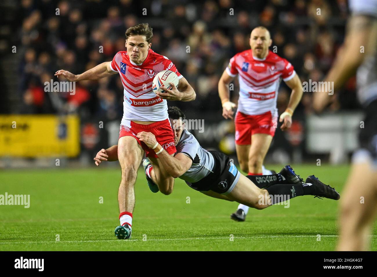 Jack Welsby (1) of St Helens is tackled by Joe Wardle (11) of Leigh ...