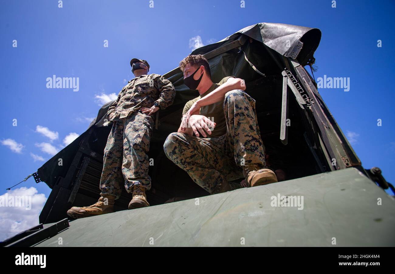 .S. Marines with 31st Marine Expeditionary Unit (MEU) help load gear as ...