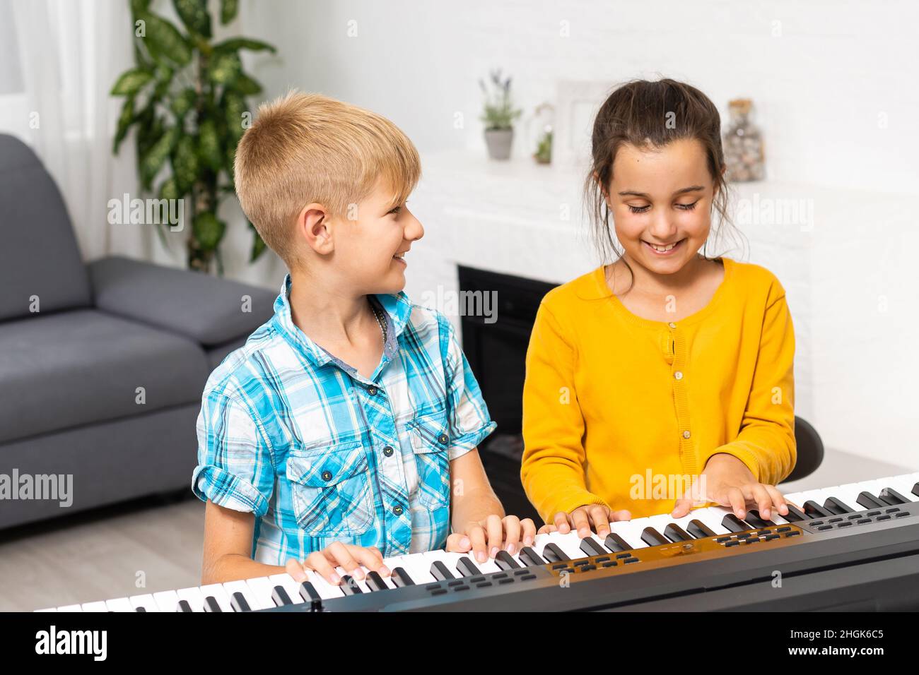 Brother and sister play the synthesizer. Children play at piano. family ...