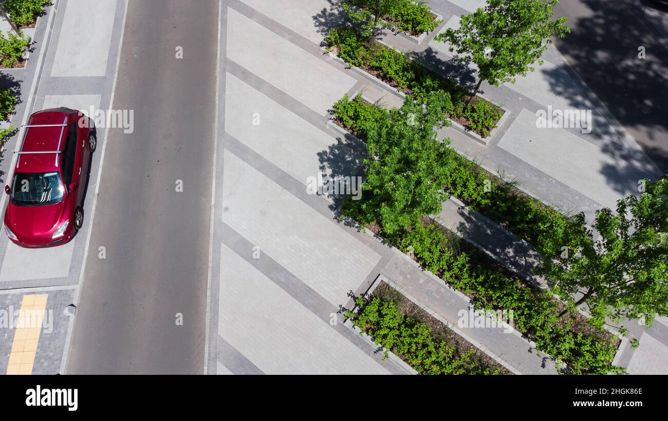 aerial top view of street with parking lot near new residential housing ...