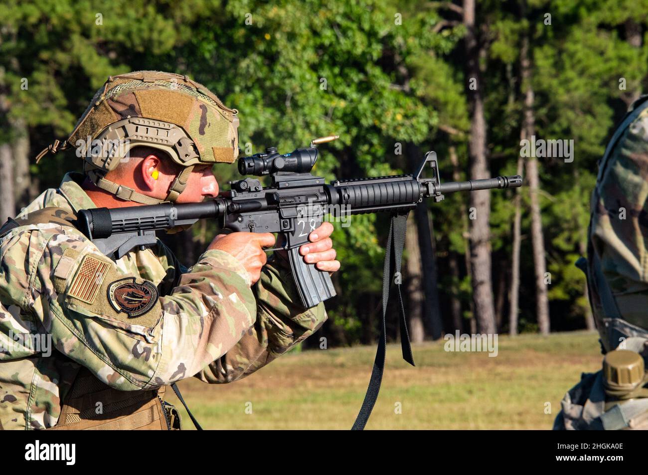 A competitor engages his target during the Combat Rifle Forward Assault ...