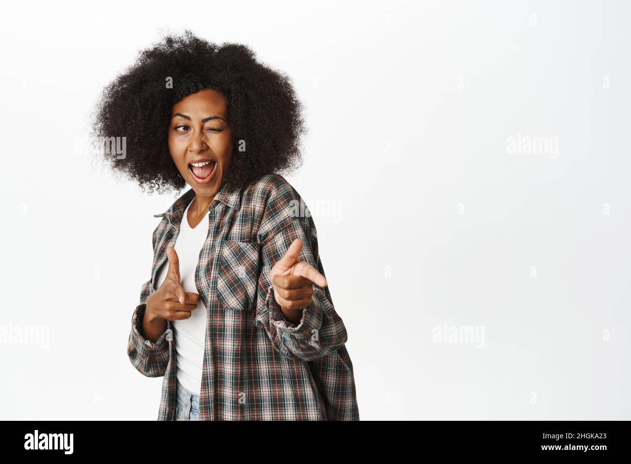 Bang. Happy african american woman pointing fingers at camera, choosing ...