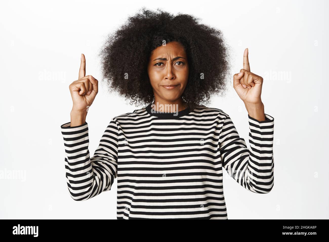 Angry black woman frowning, pointing fingers up with disapproval ...