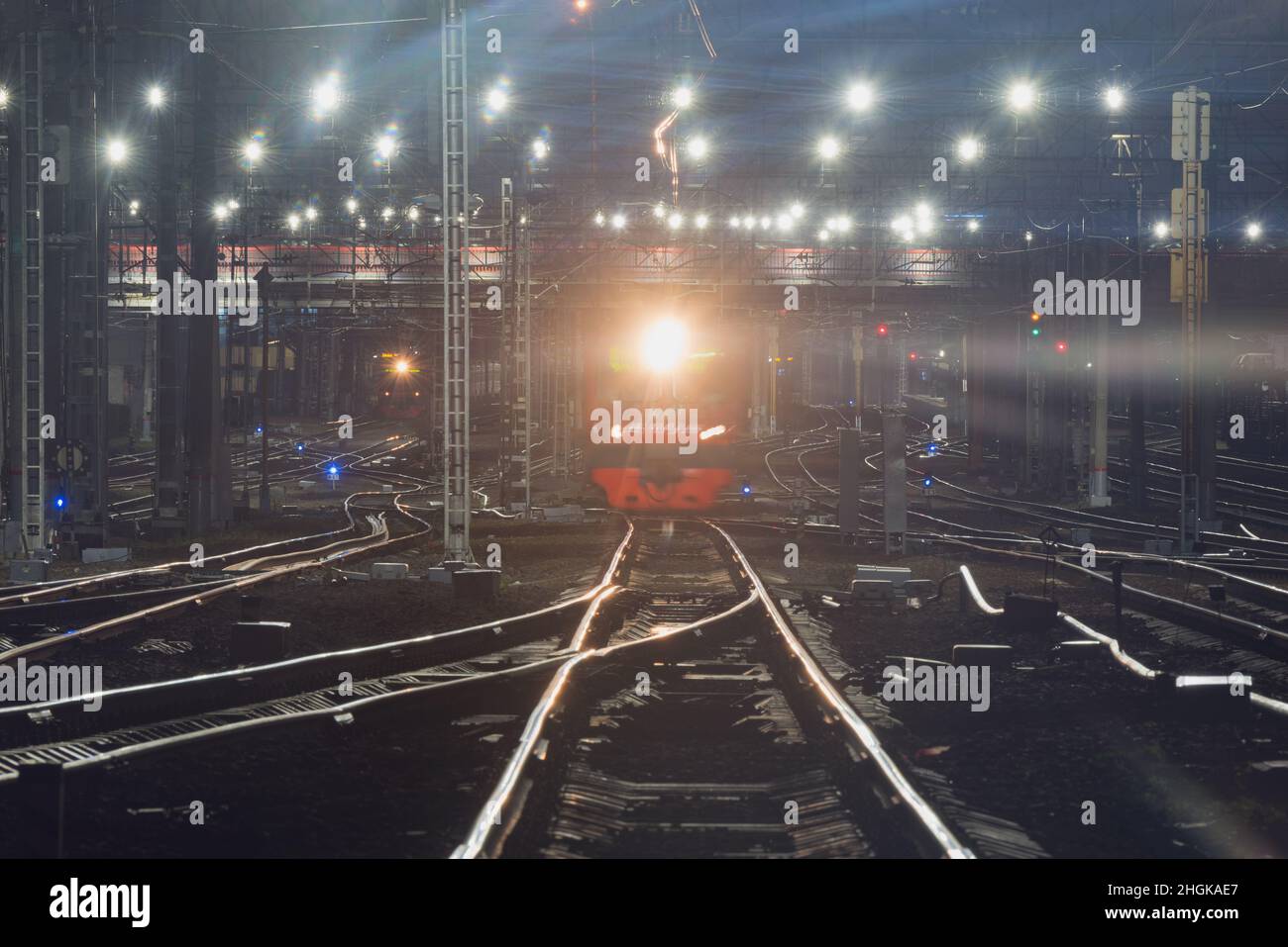 Passenger train moves fast at night time. Railway station Stock Photo ...