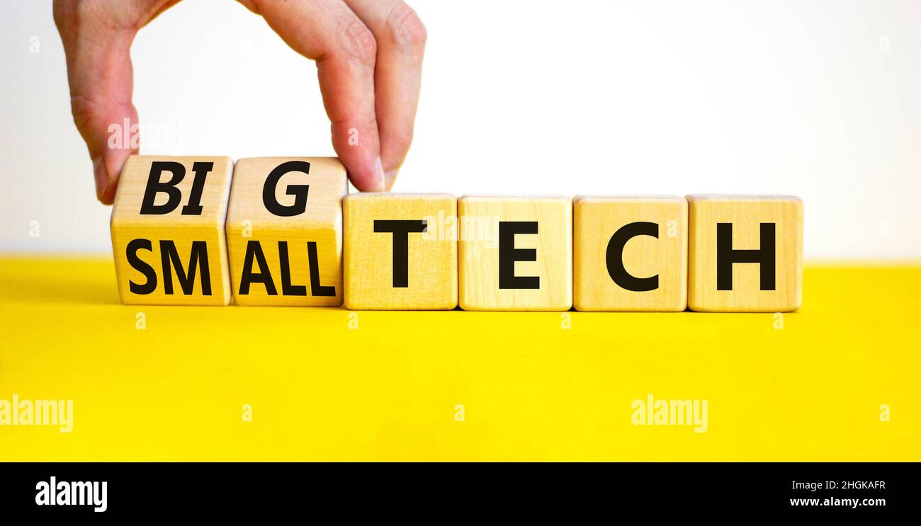 Big or small tech symbol. Businessman turns wooden cubes and changes ...