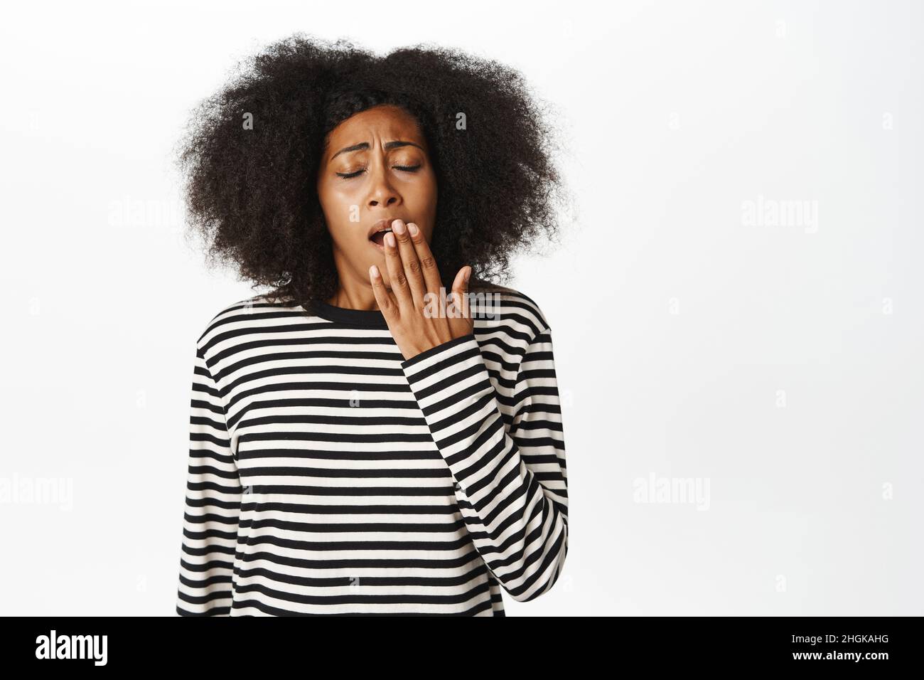 Tired Black woman with afro hair, sleeping, yawning, cover open mouth ...