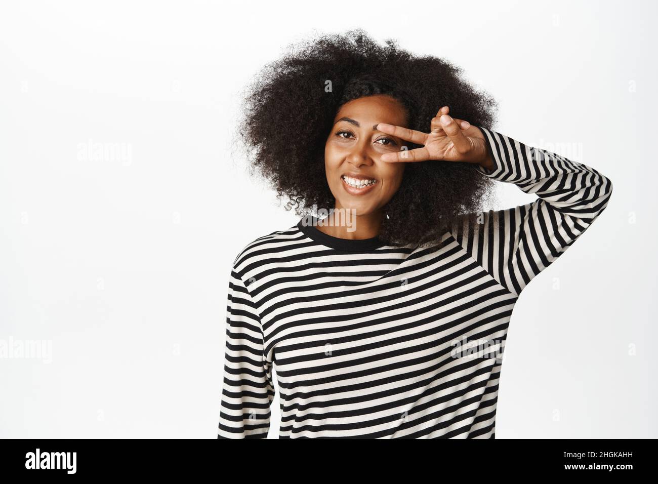 Positive african american female model, showing peace, v-sign gesture ...