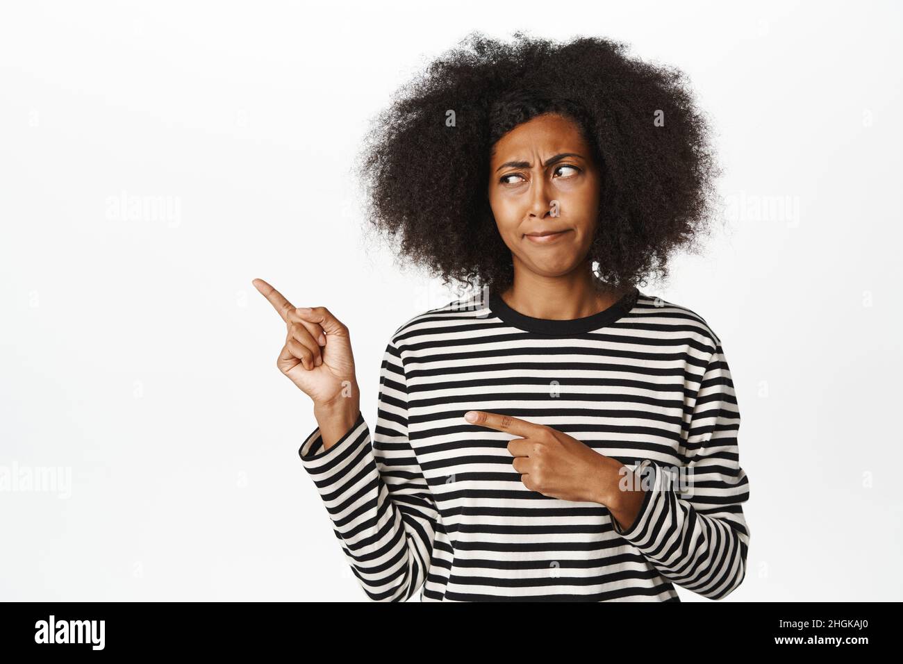 Image of young african american woman look with doubt, pointing and ...