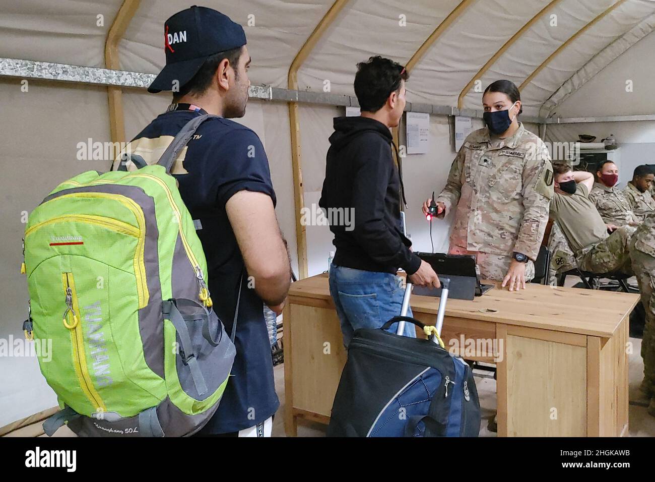 U.S. Army Soldiers help Afghan evacuee interpreters through the ...