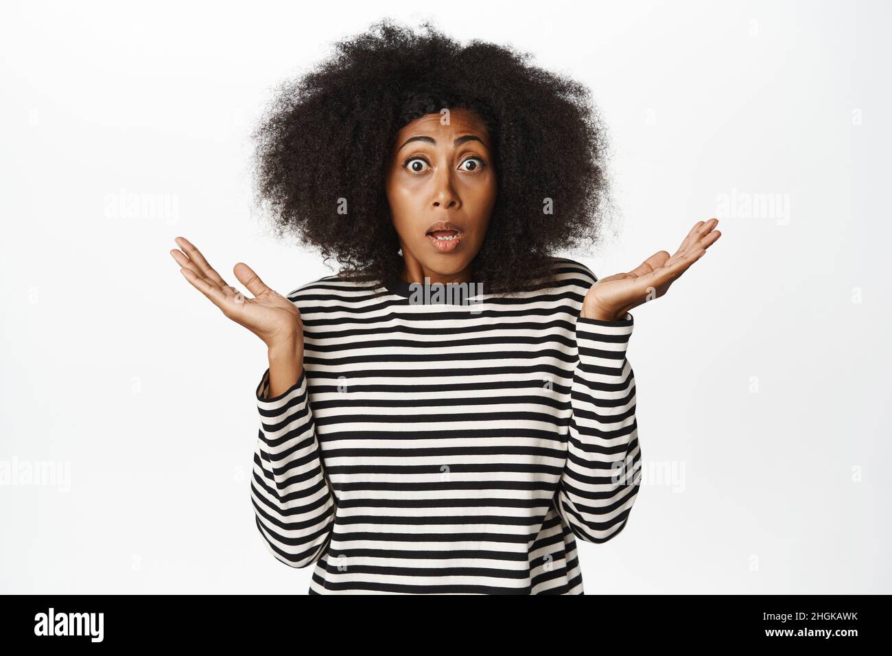 Shocked and confused african american woman, shrugging, showing empty ...