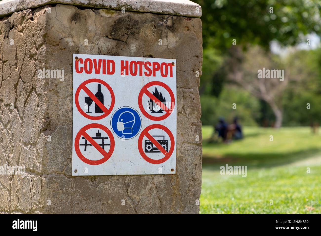 Selective focus on sign reading "Covid Hotspot" . In this area no ...