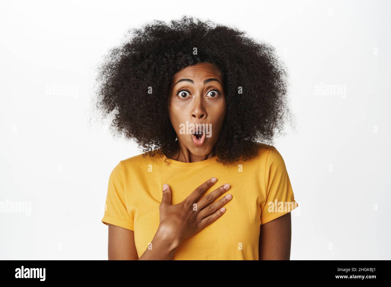 Enthusiastic Black woman looking surprised, staring impressed and ...