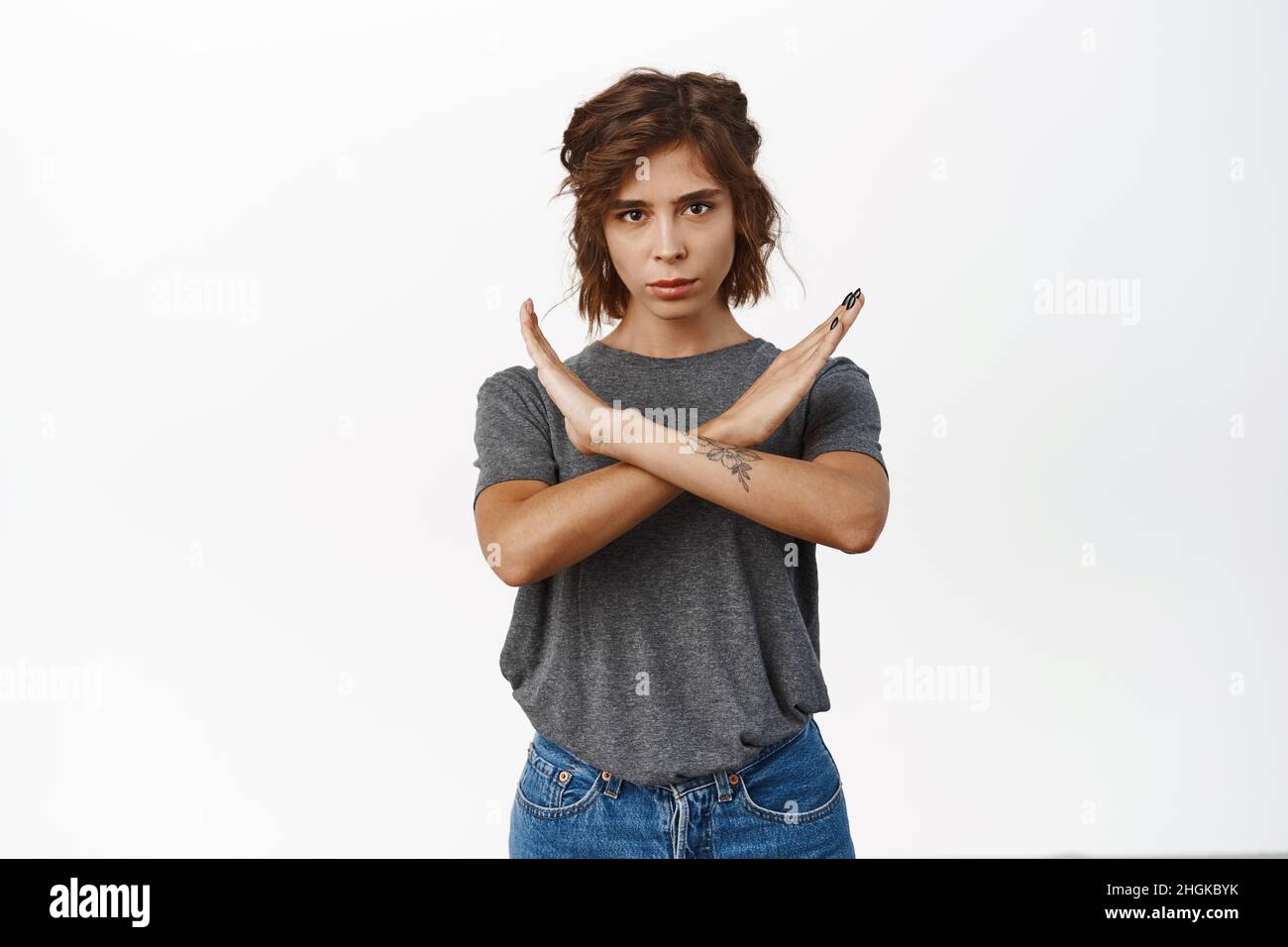 Young woman cross, showing stop, disapprove dislike gesture, decline ...