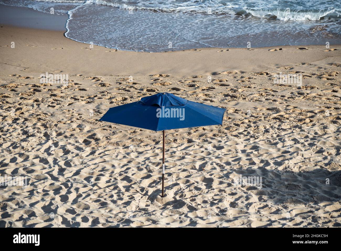 Sunshade on the beach in the strong sun of the day. Paciencia Beach in ...